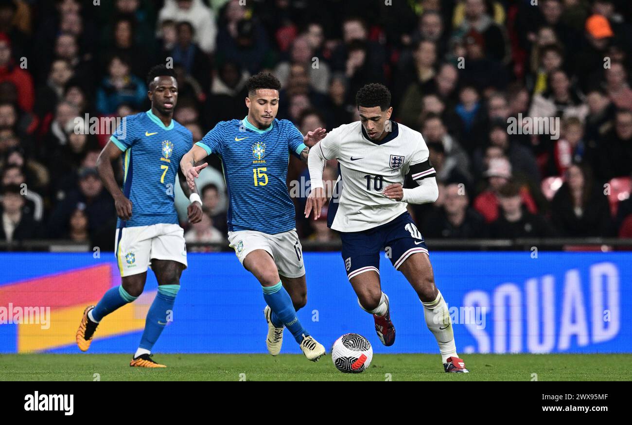 LONDON, ENGLAND - MARCH 23: Joao Gomes of Brazil and Jude Bellingham of ...