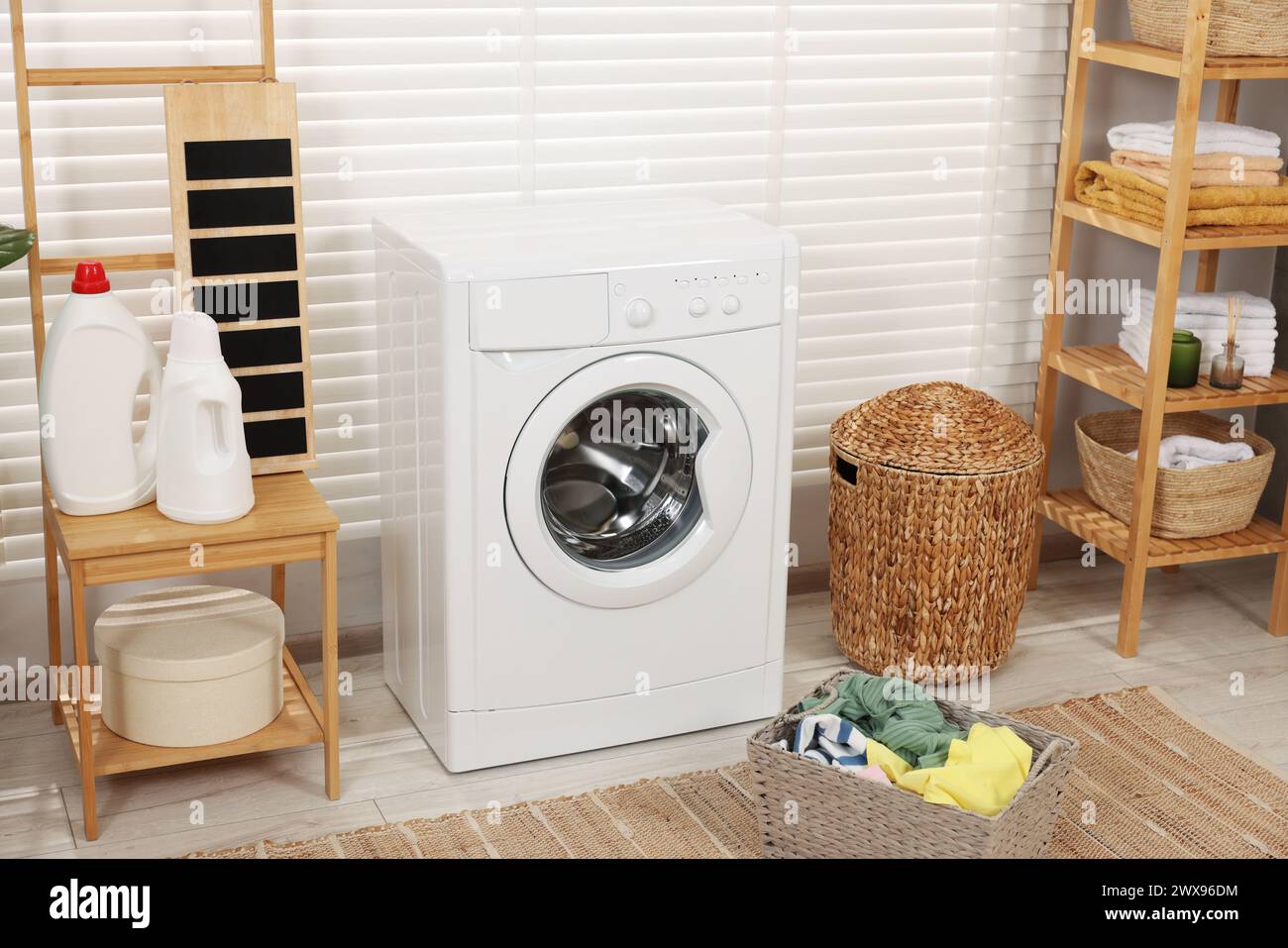 Laundry room interior with washing machine and baskets Stock Photo - Alamy