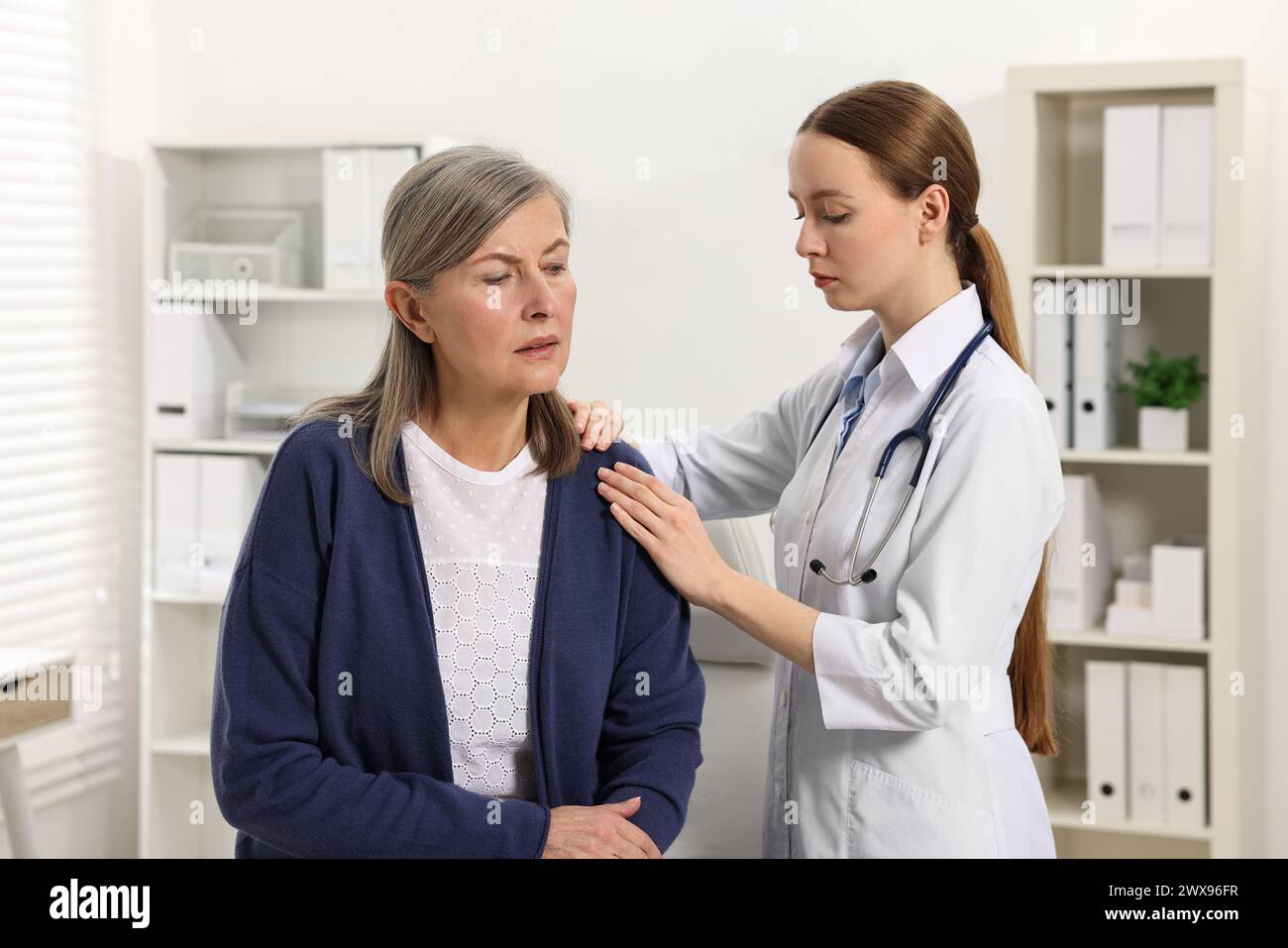 Arthritis symptoms. Doctor examining patient with shoulder pain in ...