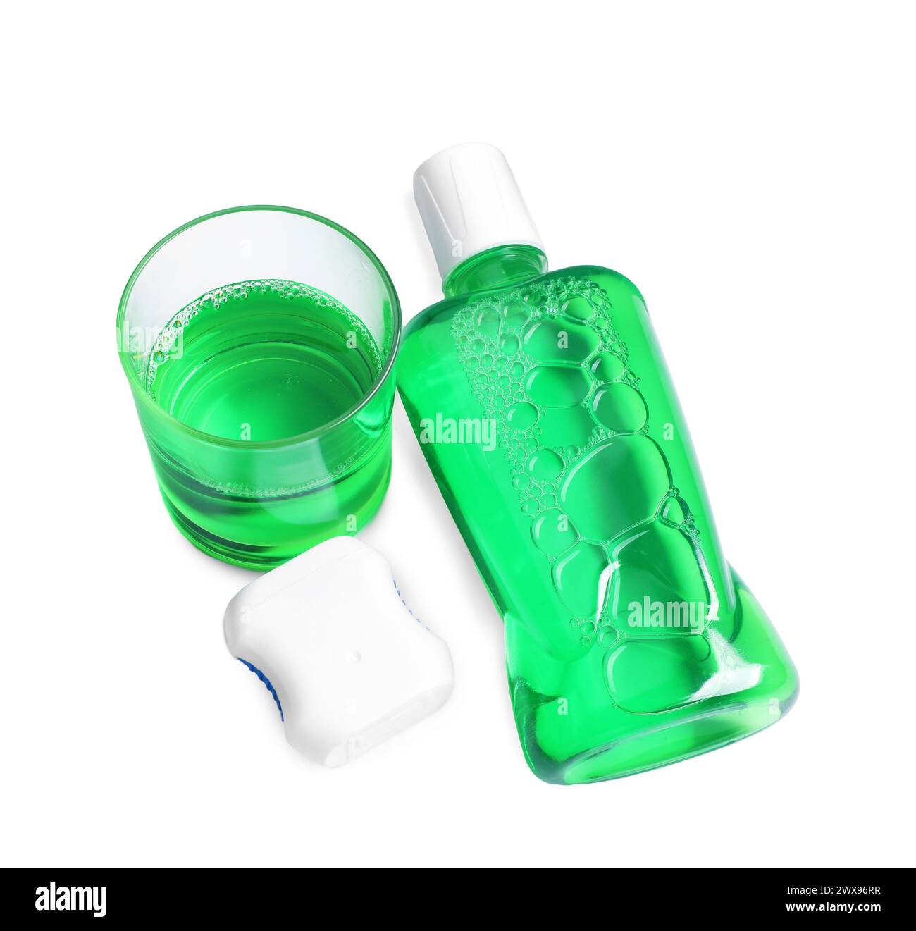 Fresh mouthwash, bottle, glass and dental floss isolated on white ...