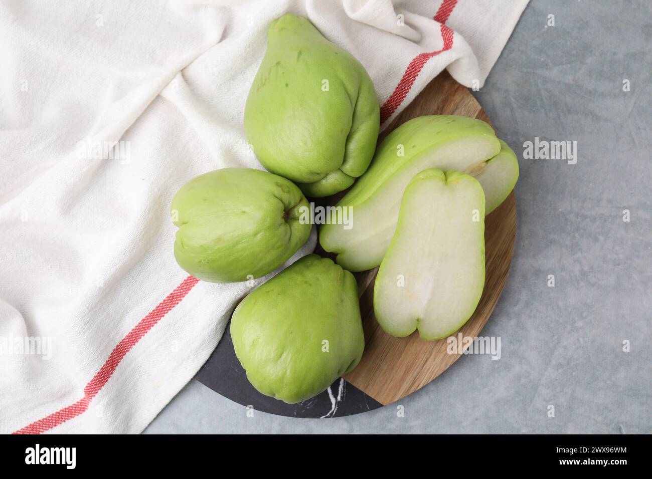 Cut and whole chayote on gray table, top view Stock Photo - Alamy