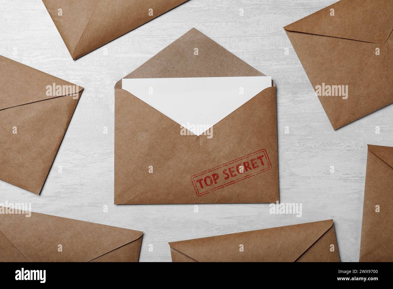 Top Secret stamp. Paper envelopes on light grey table, flat lay Stock ...
