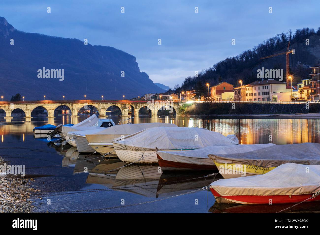 Pier and boats docked at marina on Lake Como in the harbor of the city ...