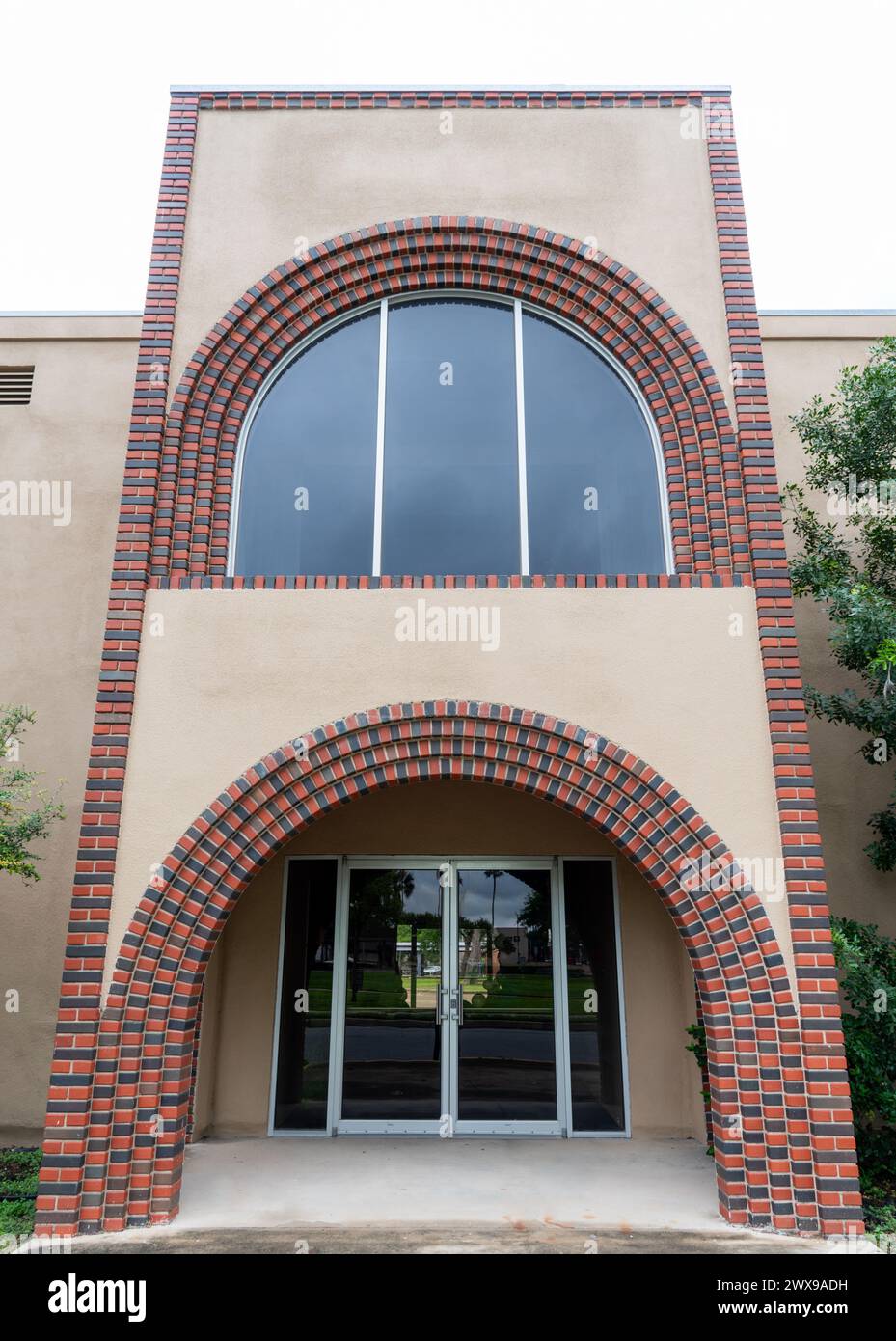 Facade of mid-century modern two-story commercial building with brick ...