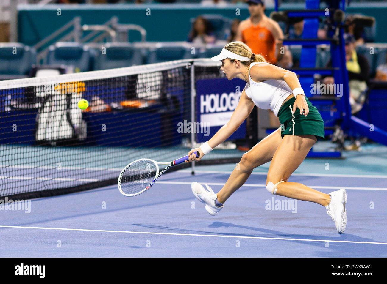 MIAMI GARDENS, FLORIDA - MARCH 28: Danielle Collins returns a shot ...