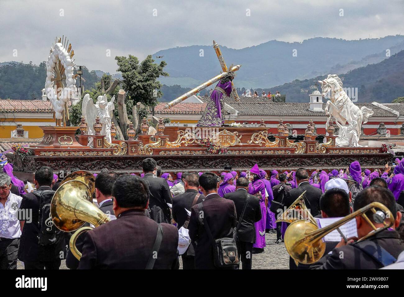 Antigua, Guatemala. 28th Mar, 2024. A marching band follows the massive ...