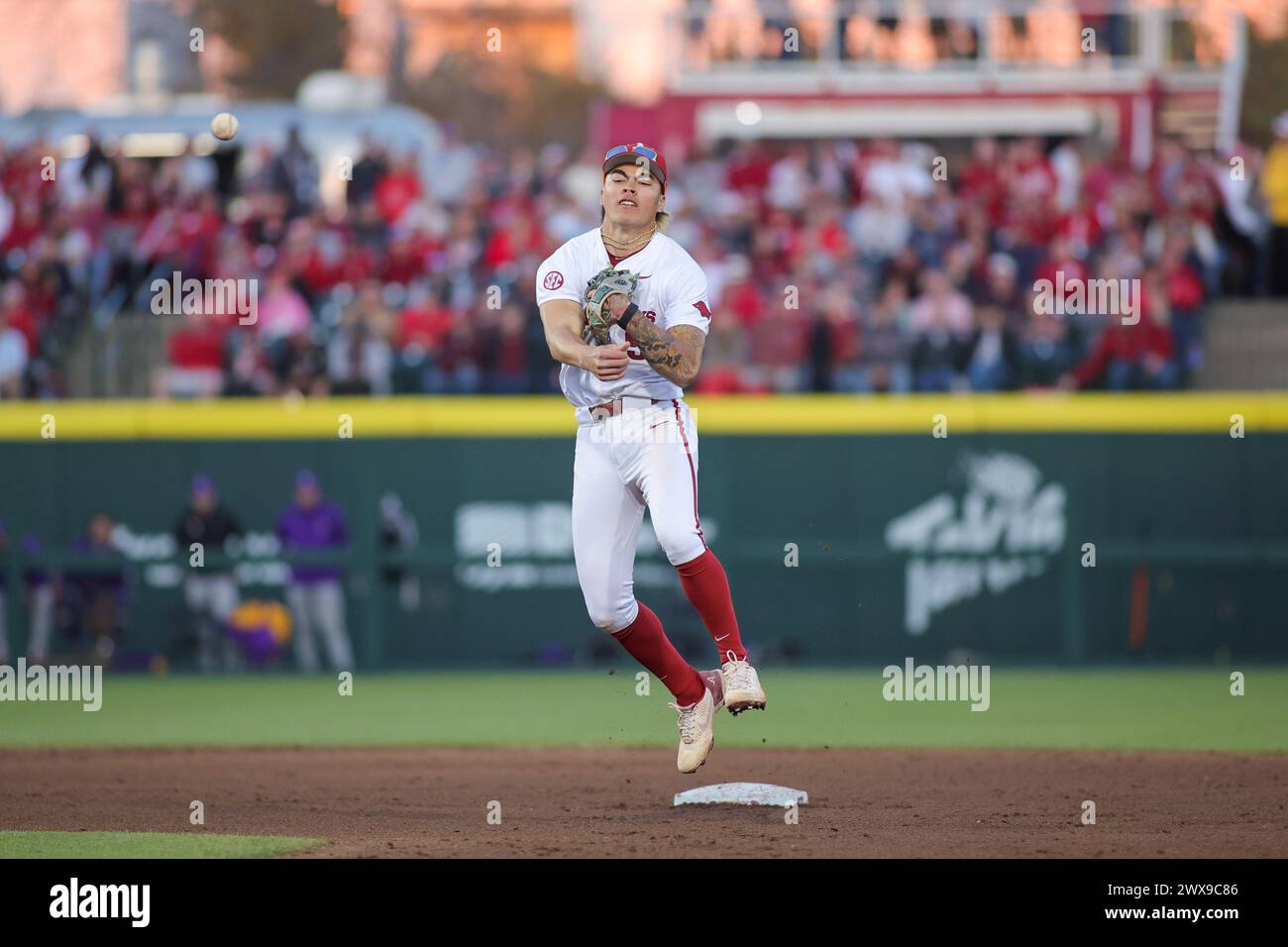 March 28, 2024: Wehiwa Aloy #9 Razorback infielder makes a throw over ...