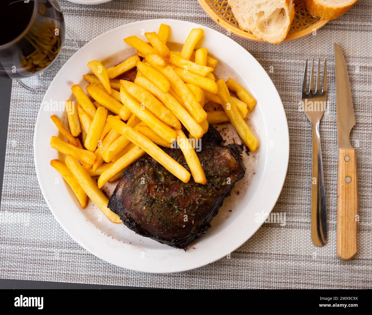 Deep-fried pork chop with French fries,served with red wine Stock Photo ...