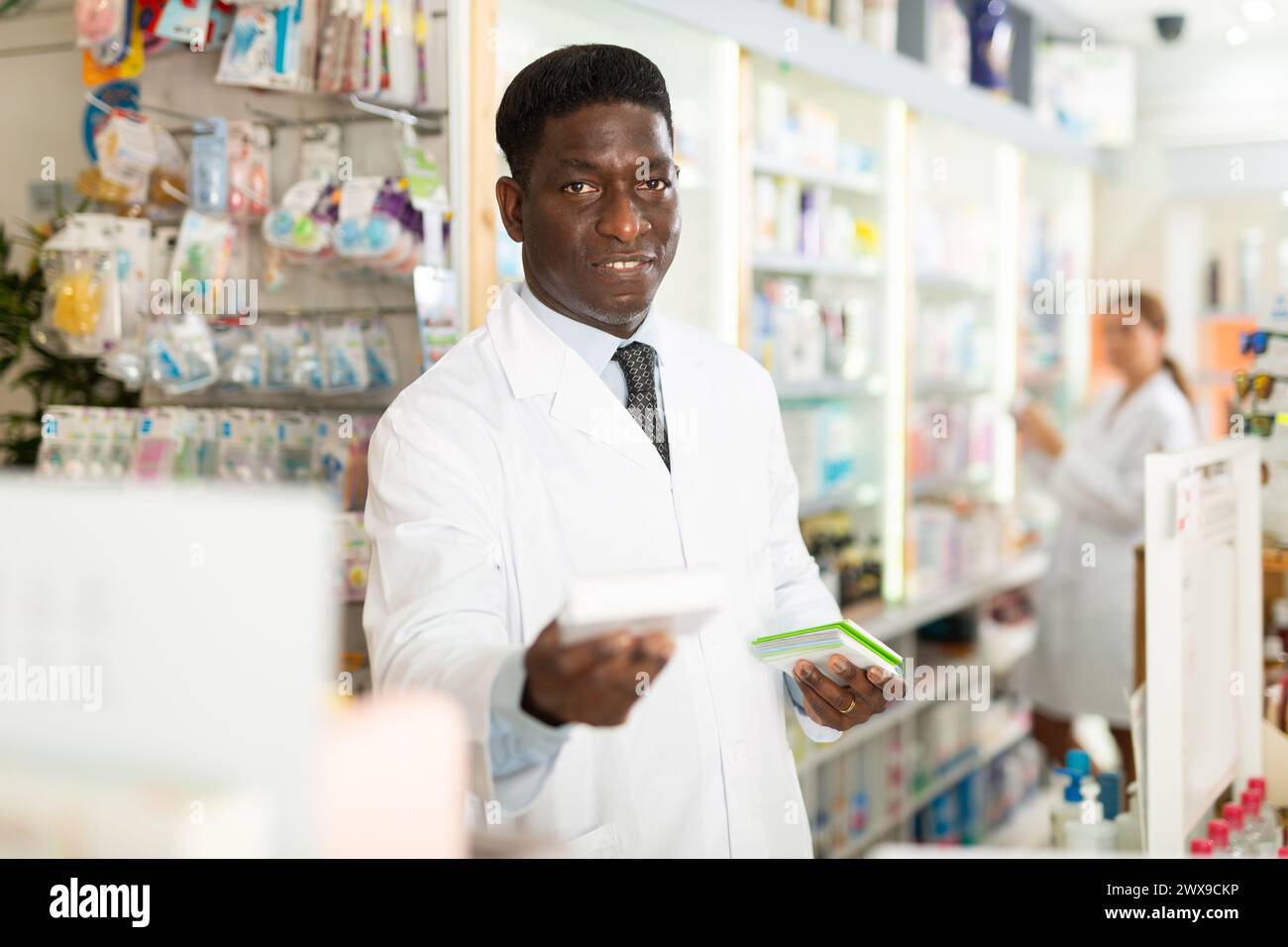 Pharmacist showing drug package Stock Photo - Alamy