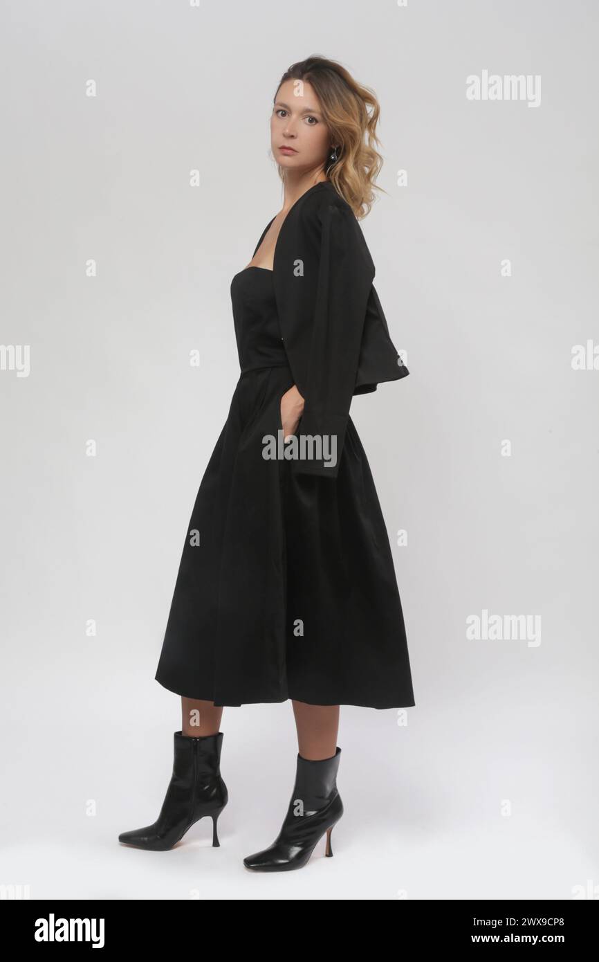 Serie of studio photos of female model wearing black blazer and black ...