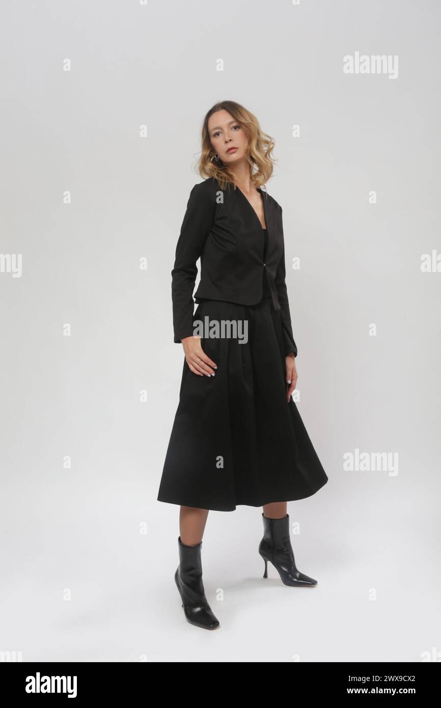 Serie of studio photos of female model wearing black blazer and black ...