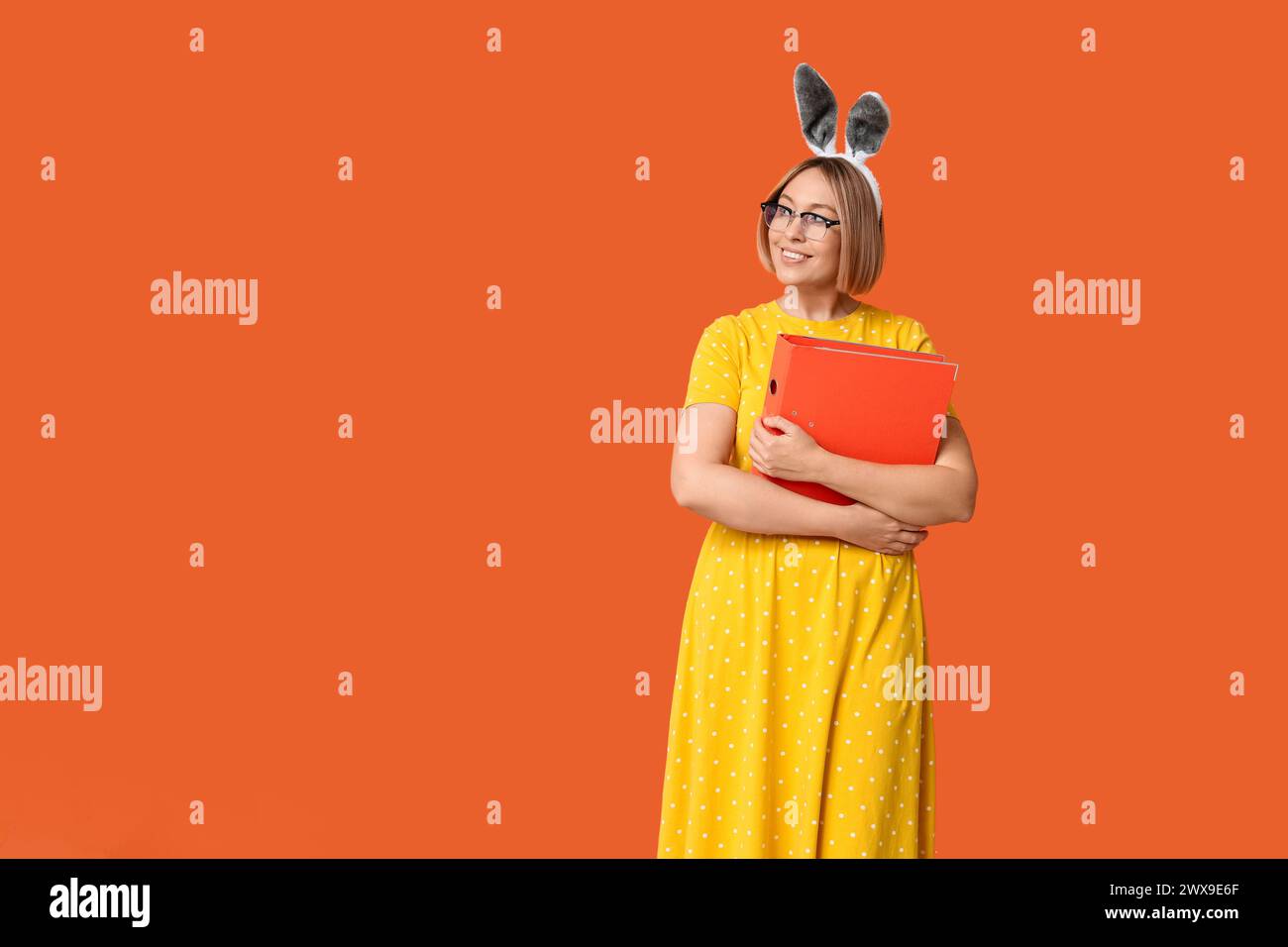 Happy adult female secretary in bunny ears with documents folder on ...
