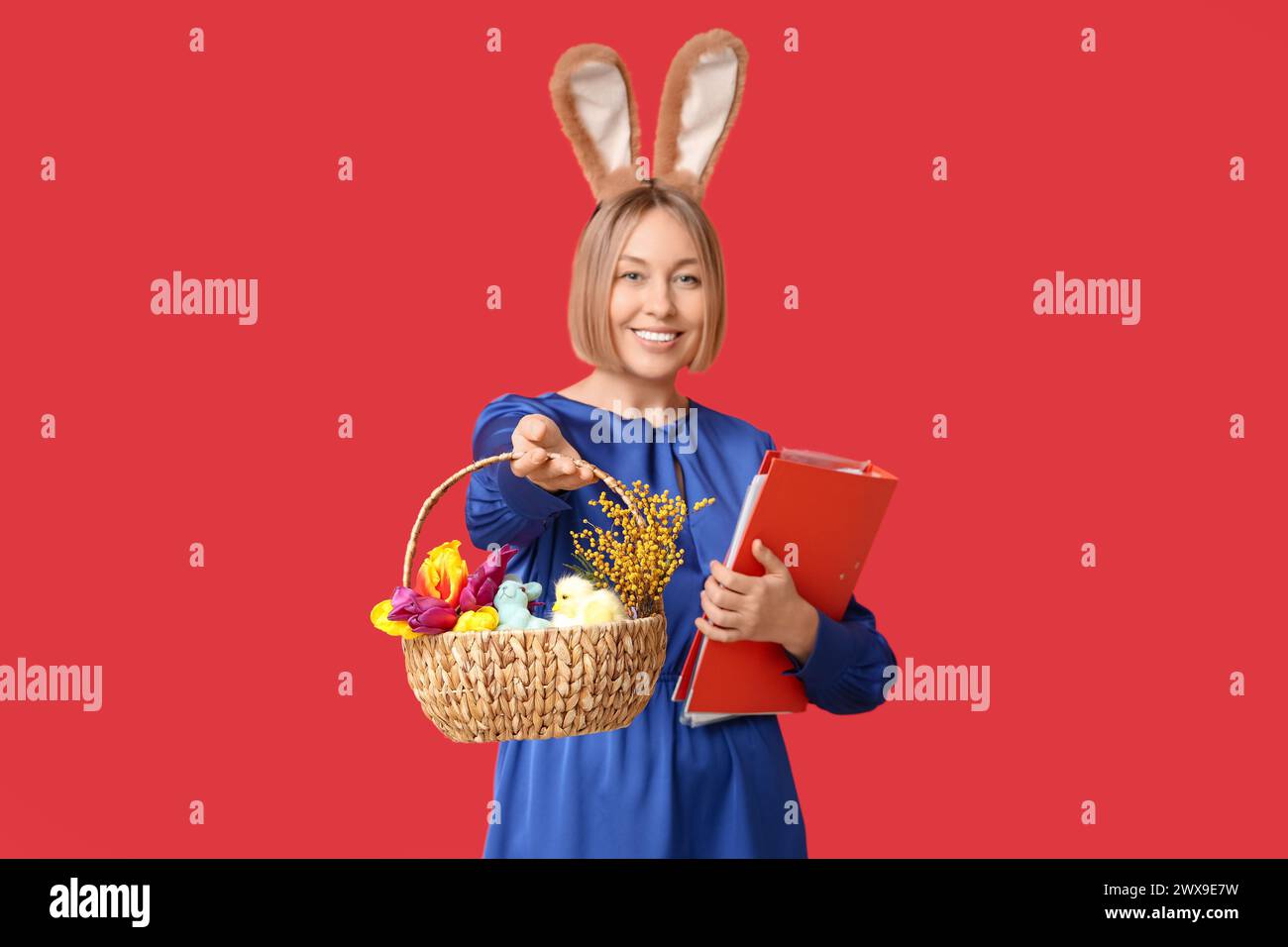Happy adult female secretary in bunny ears with documents folder and ...