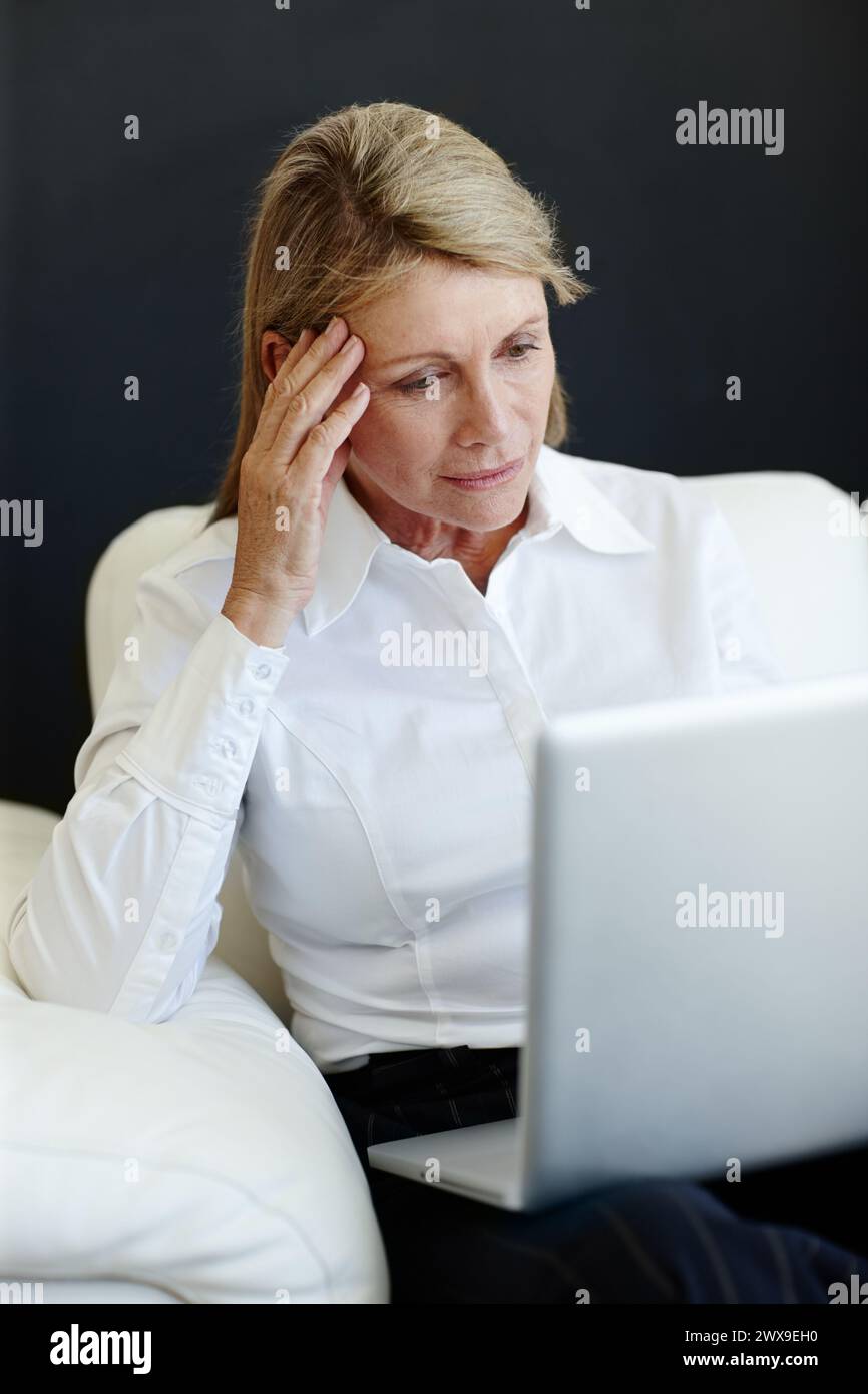 Mature businesswoman, stress and laptop for thinking, planning and ...