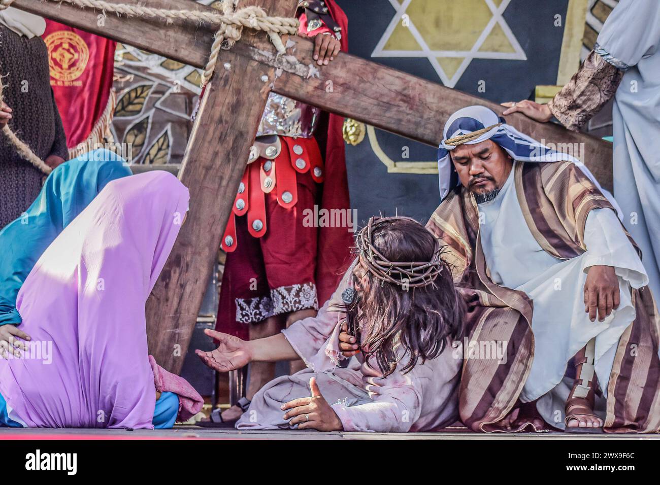 Antipolo, Philippines. 29th Mar, 2024. A group reenacts in the streets ...