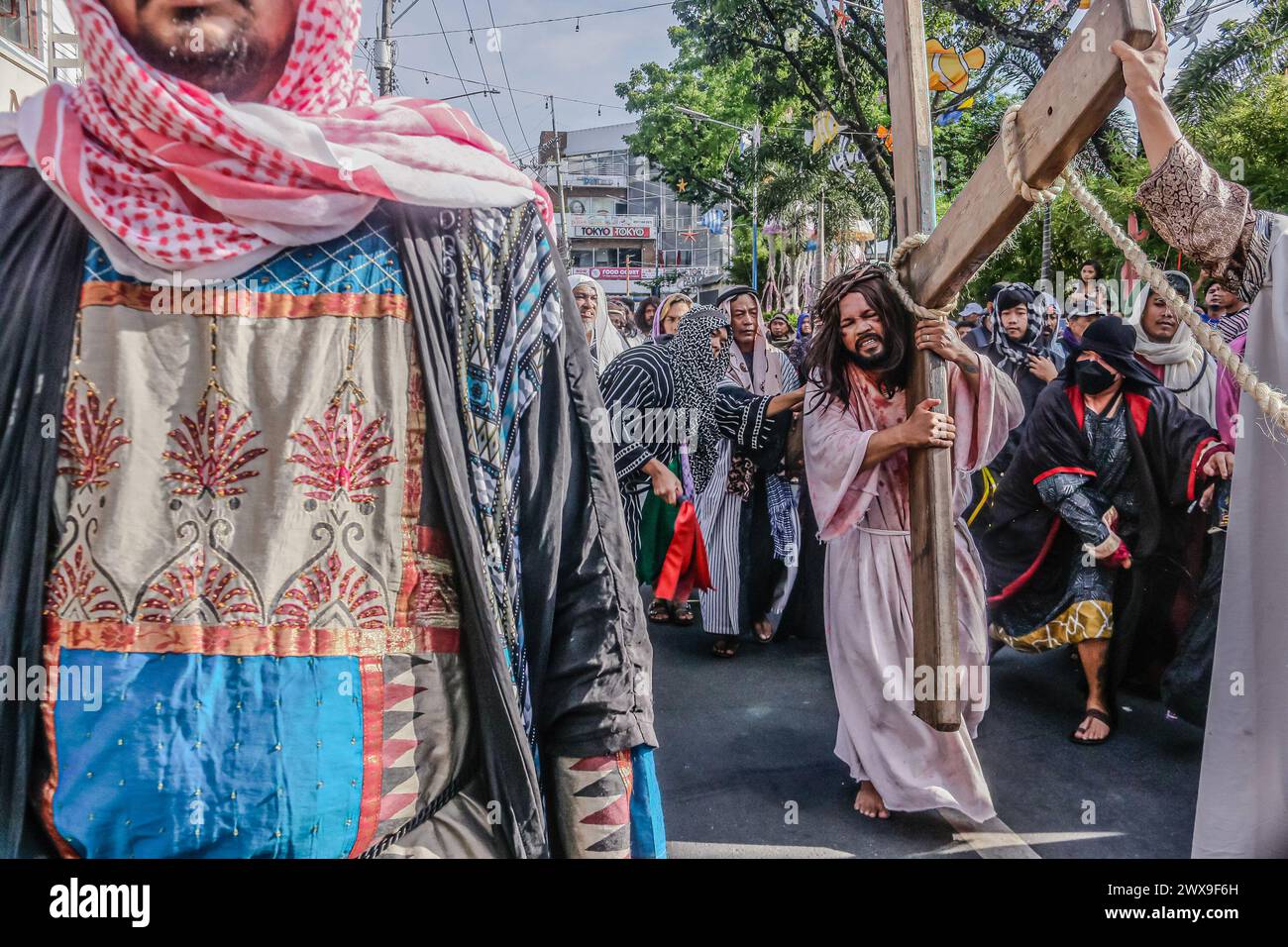 Antipolo, Philippines. 29th Mar, 2024. A group reenacts in the streets ...