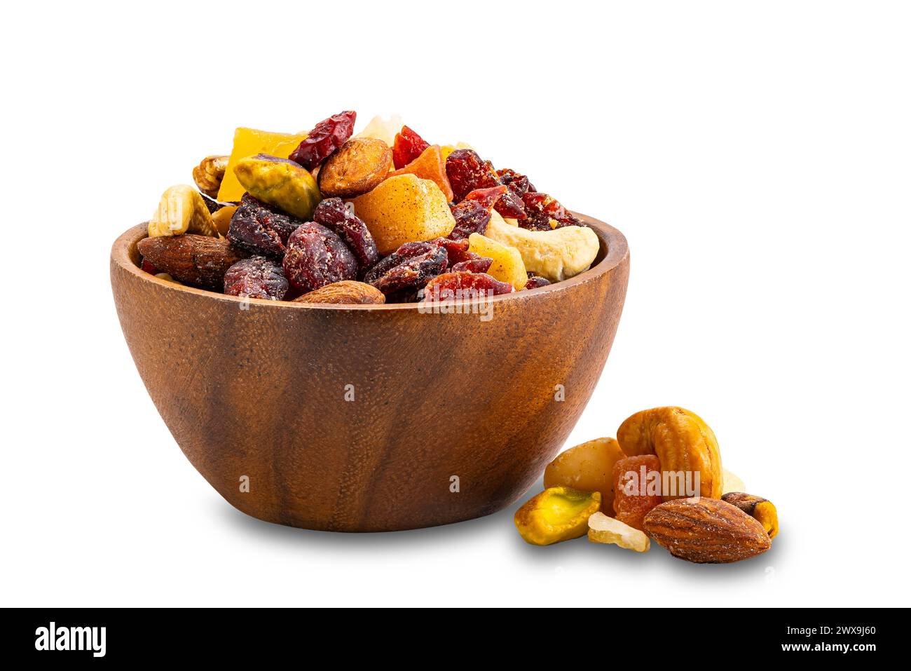 Breakfast mix nuts and fruits in wooden bowl and pile on the floor ...