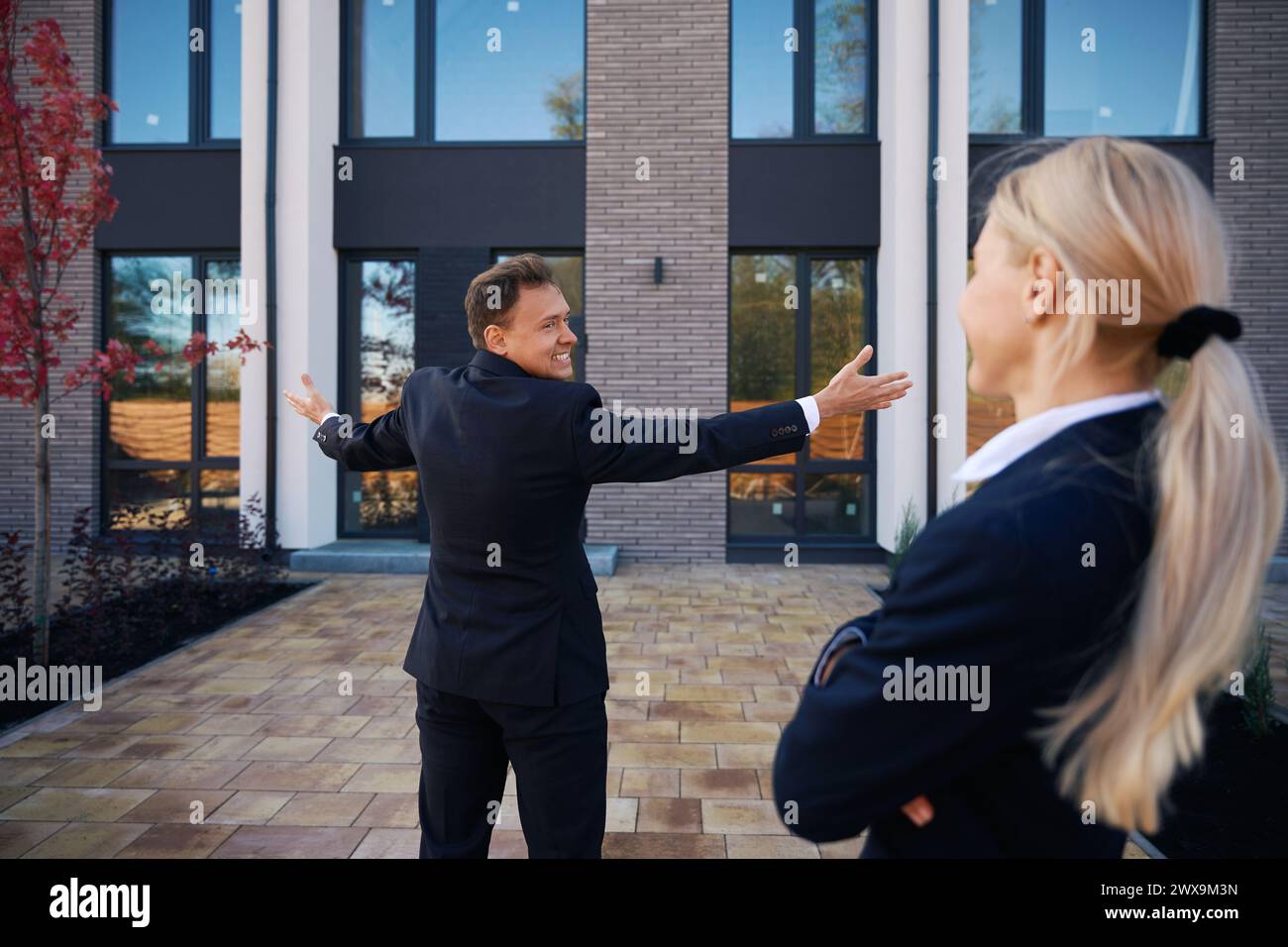 Businessman businesswoman presenting house hi-res stock photography and ...