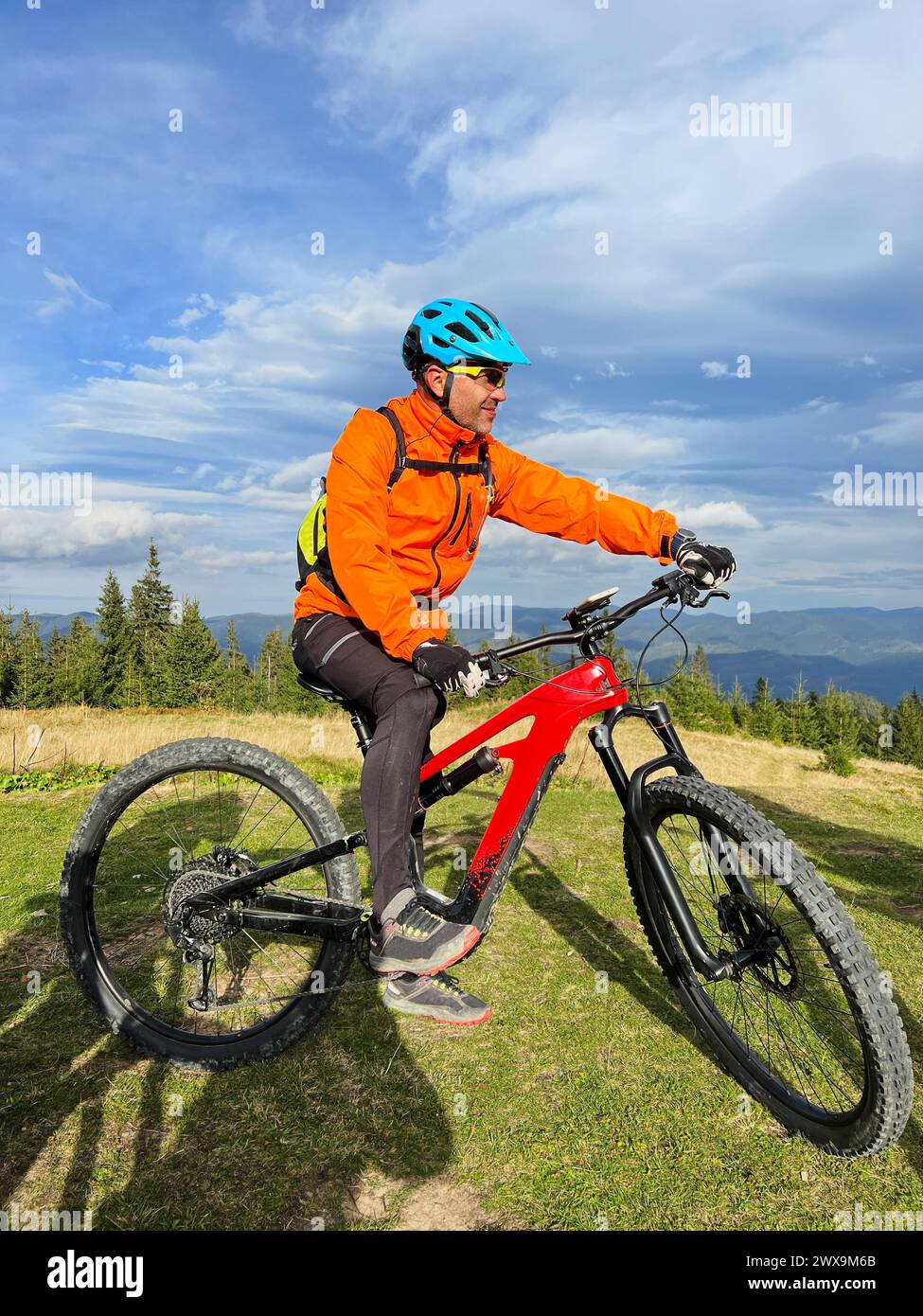Cyclist man riding electric bike outdoors on sunny day. Male tourist ...