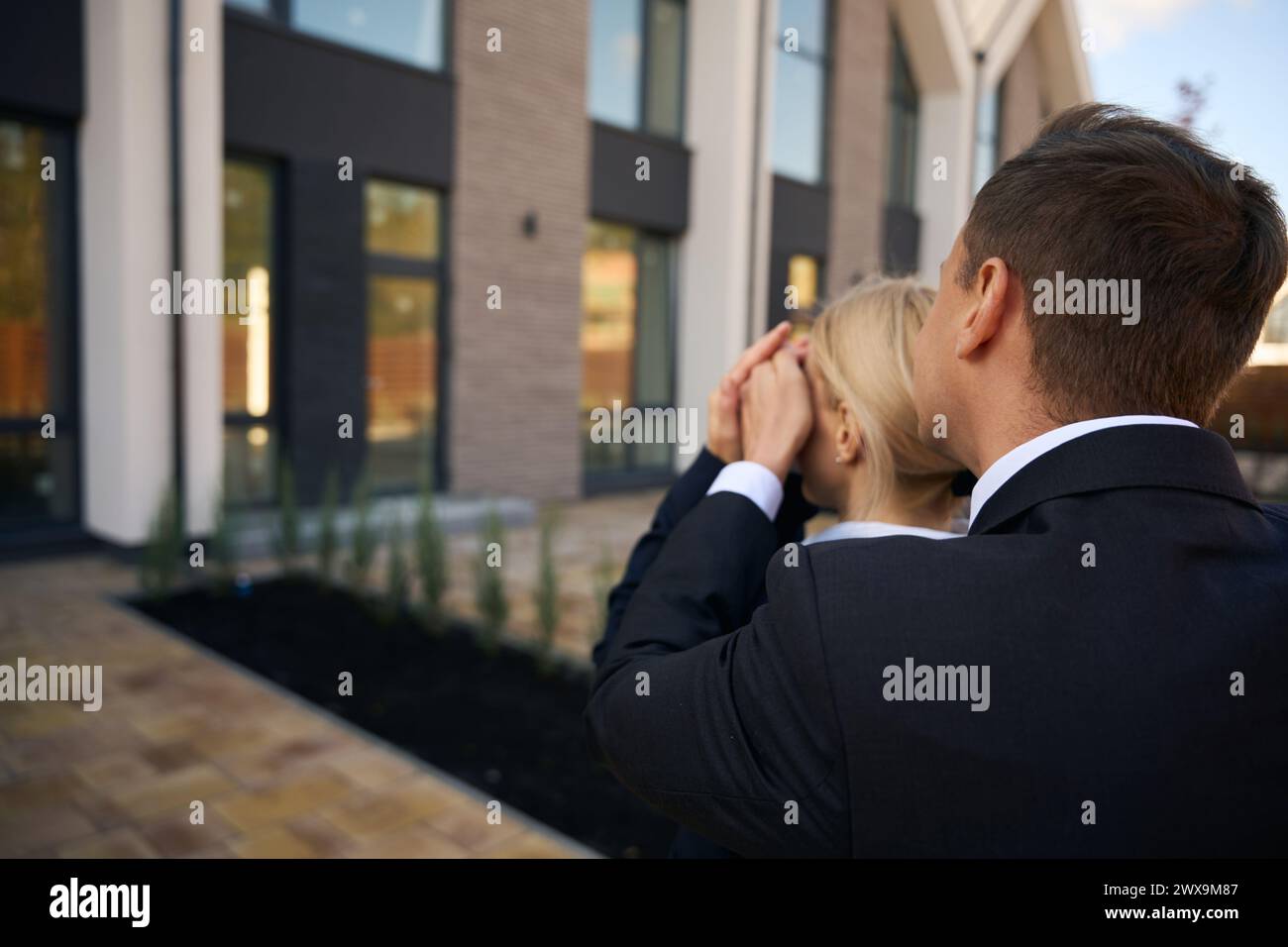 Back view picture of adult couple standing outside house Stock Photo ...