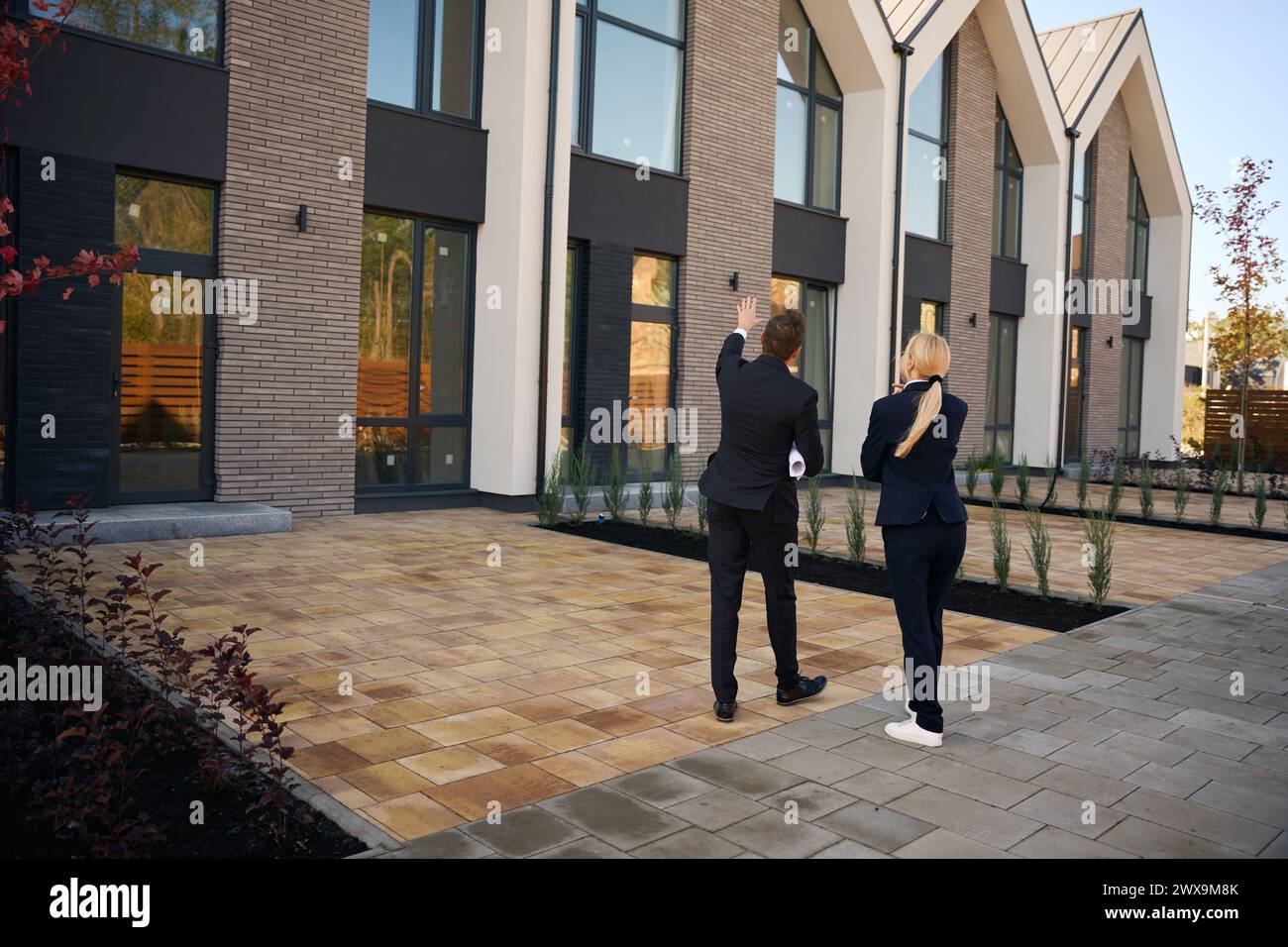 Back view picture of client and realtor walking near buildings Stock ...