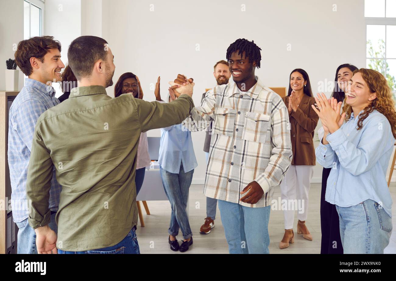 Smiling Diverse Group of Friends in a Circle Handshaking Stock Photo ...
