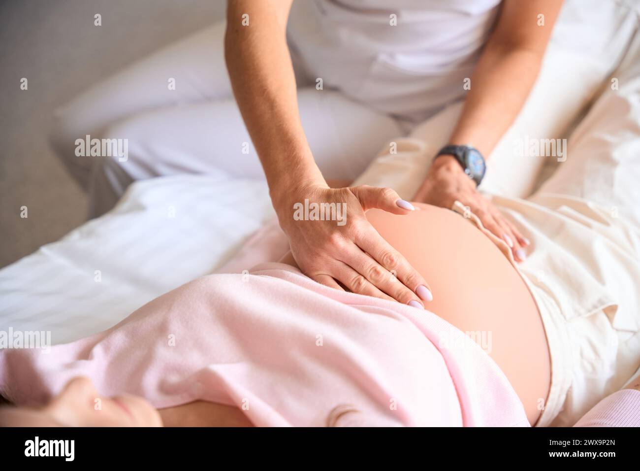 Unrecognizable female doctor examining pregnant belly healthcare check ...