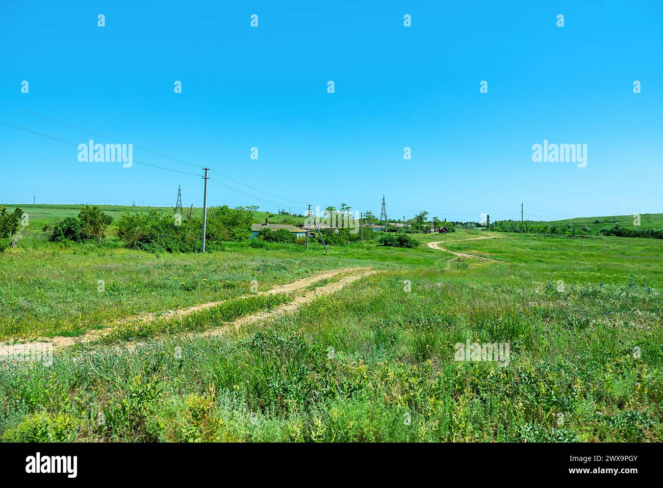 Steppe village (tatar hamlet) in the dry balka, dirt field road. Crimea ...