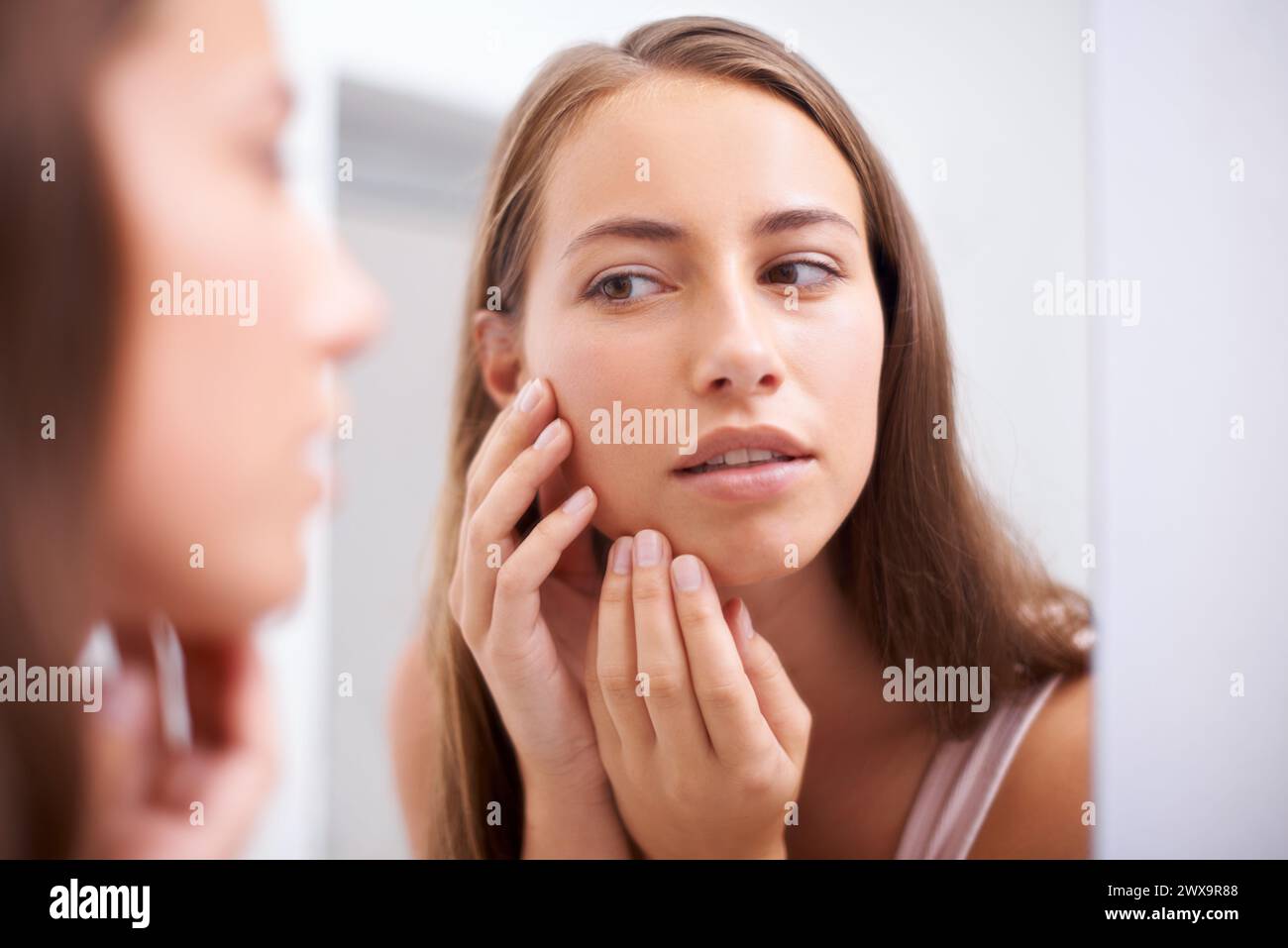 Face, beauty and pimple with woman in bathroom of home for skincare ...
