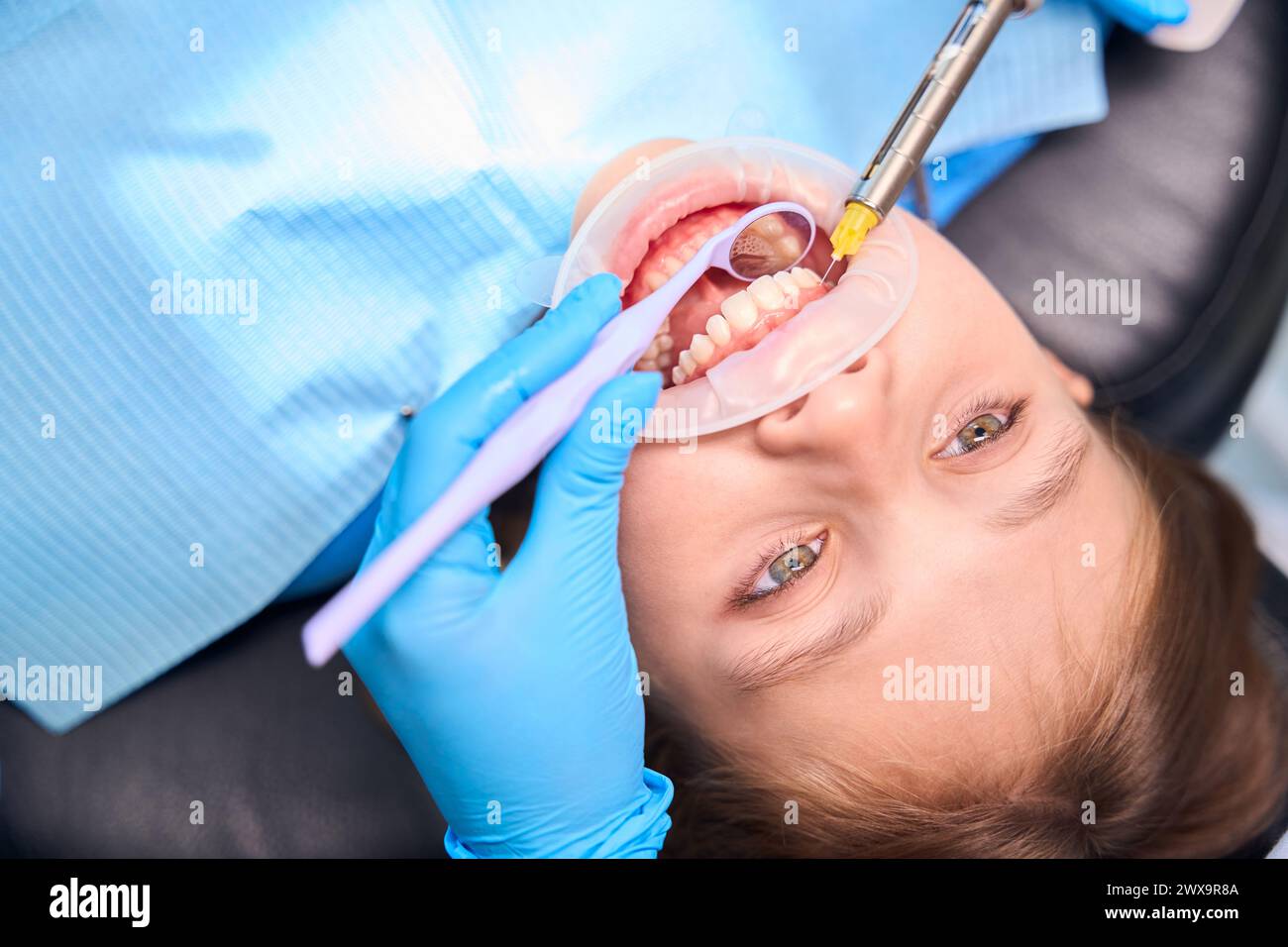 Dentist gives anesthesia injection into the gums of teenage girl Stock ...