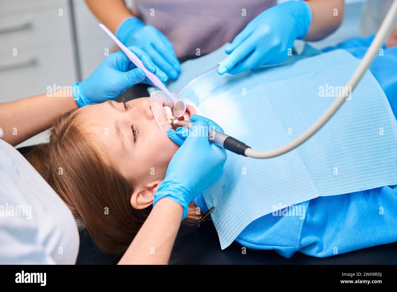 Girls tooth is drilled in a dental clinic Stock Photo - Alamy