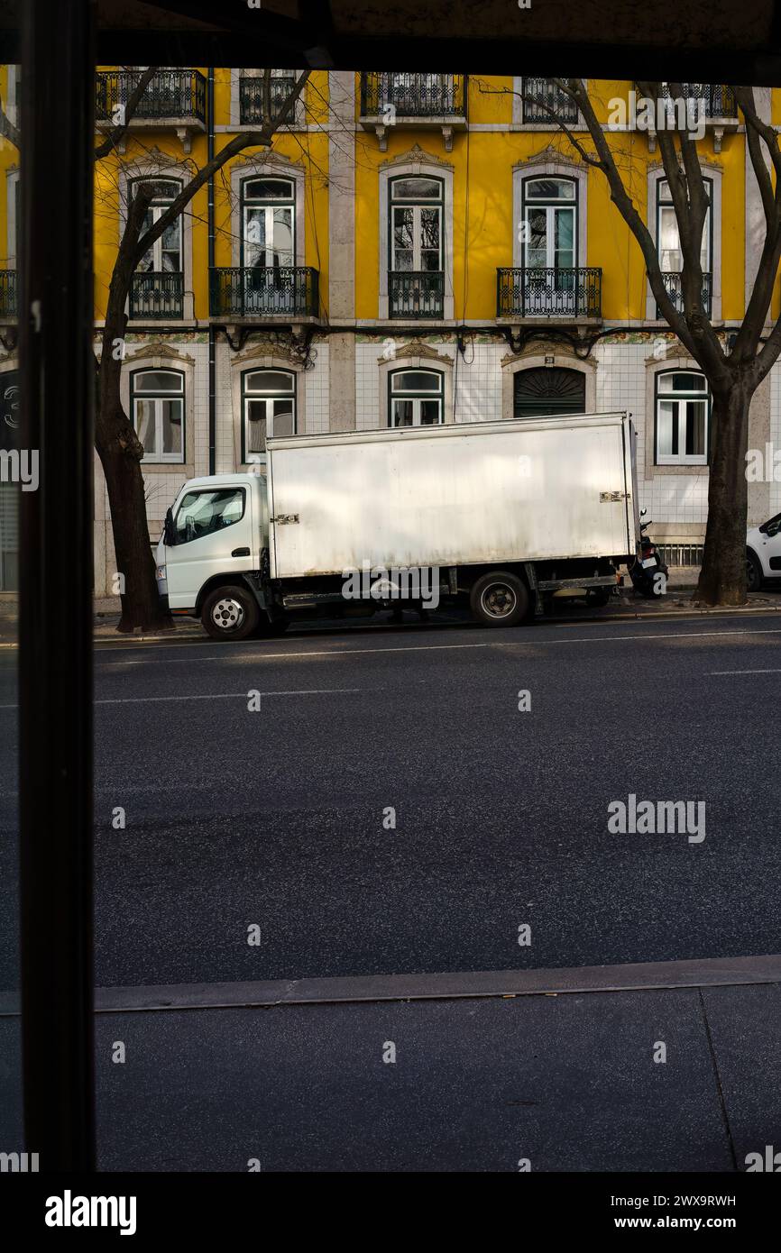 White lorry parked in front of historic european building Stock Photo ...
