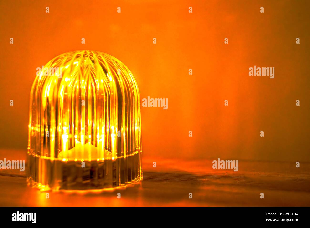 A soft yellow night light graces the table, casting a warm and cozy ...