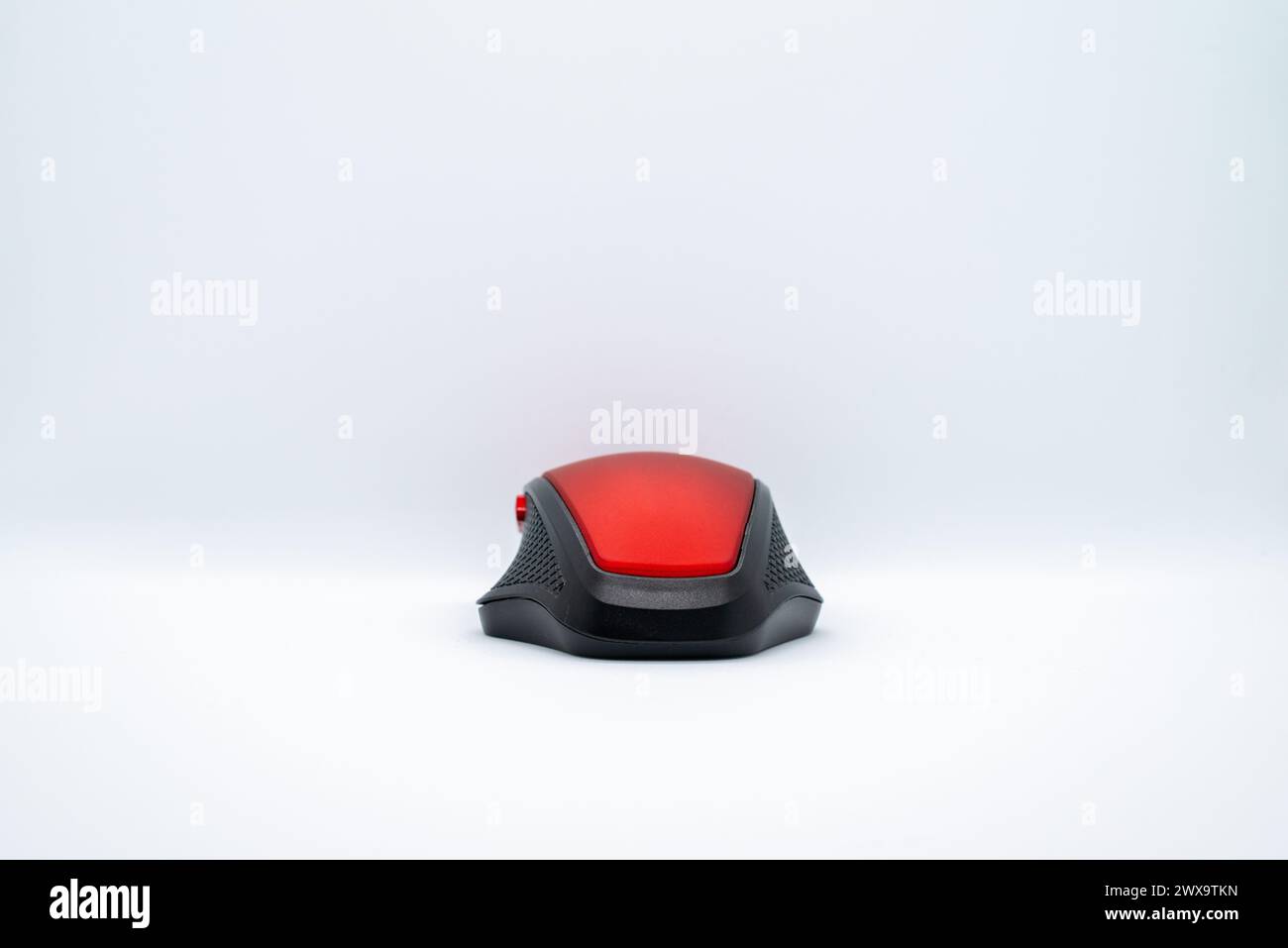 A sleek red mouse on a clean white background, blending style with ...
