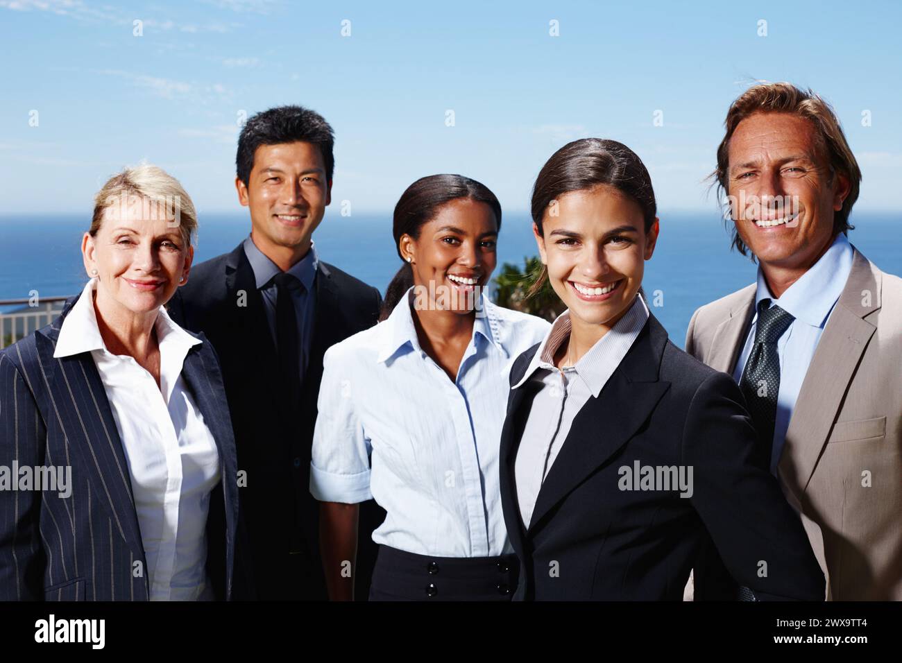 Balcony, portrait and business people in nature by ocean for team ...