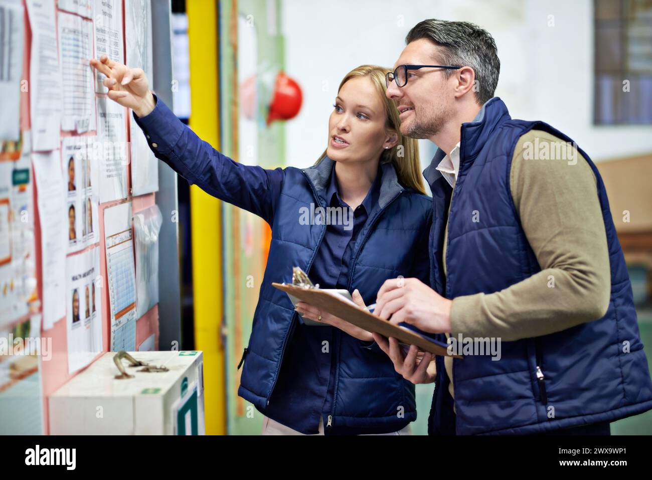 People, business and checking schedule with board in warehouse with ...