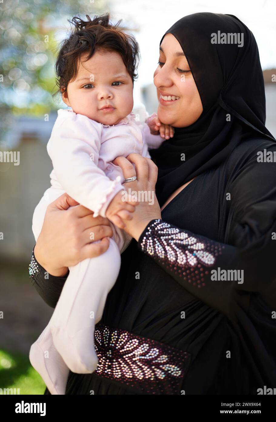 Baby girl, hug and Muslim mom in hijab outside house for religious ...