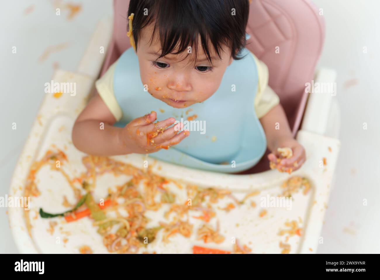 infant baby eating food and vegetable by self feeding BLW or baby led ...