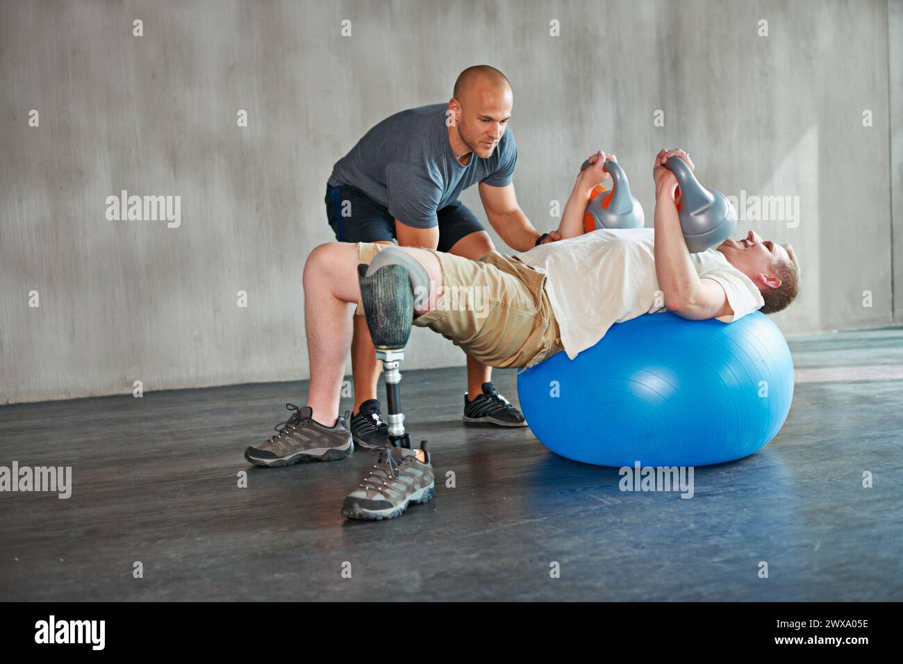 Physiotherapy, patient or man with disability and kettlebells for ...
