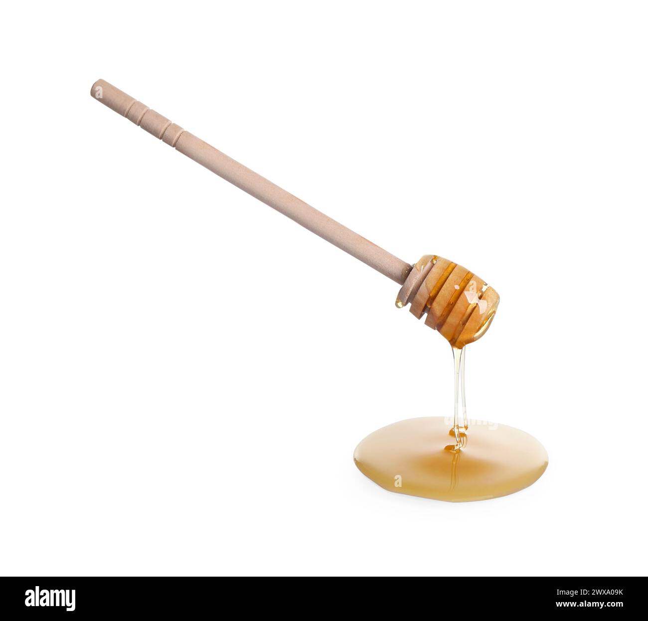 Fresh honey dripping from dipper on white background Stock Photo - Alamy