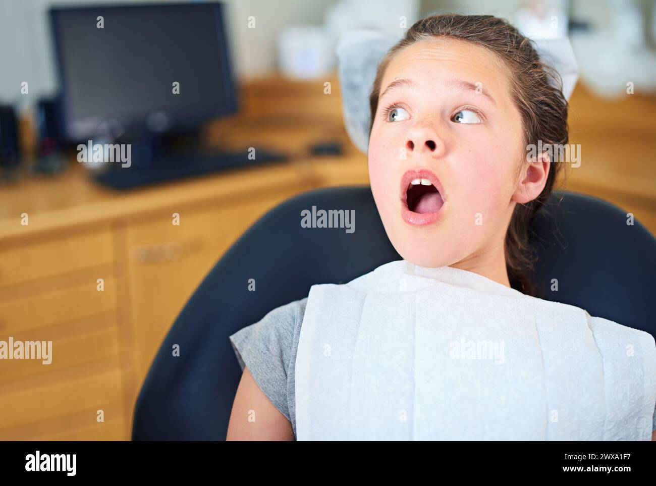 Dental, wow or scared girl in consultation room with phobia, worry or ...