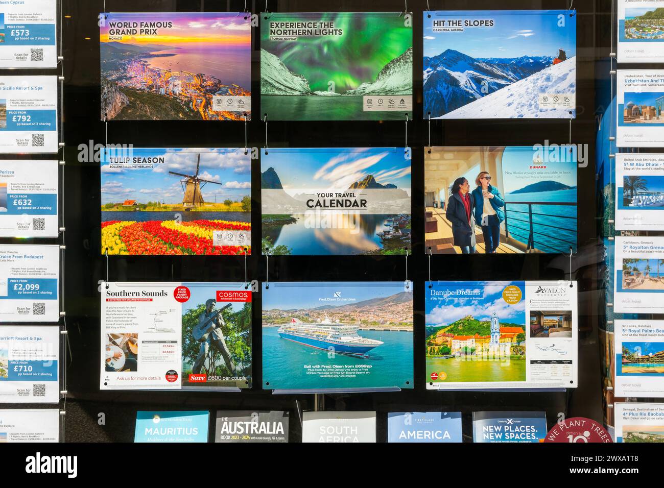 Colourful picture advertising holidays in shop window of travel agent ...