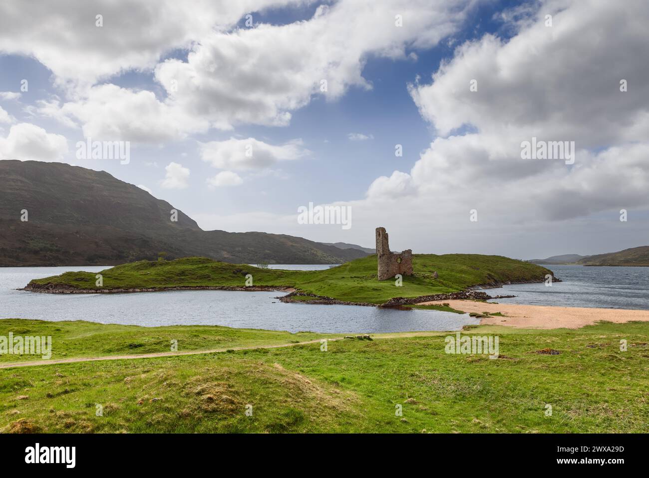 Ardvreck Castle's ruins standing on a narrow strip of land between a ...