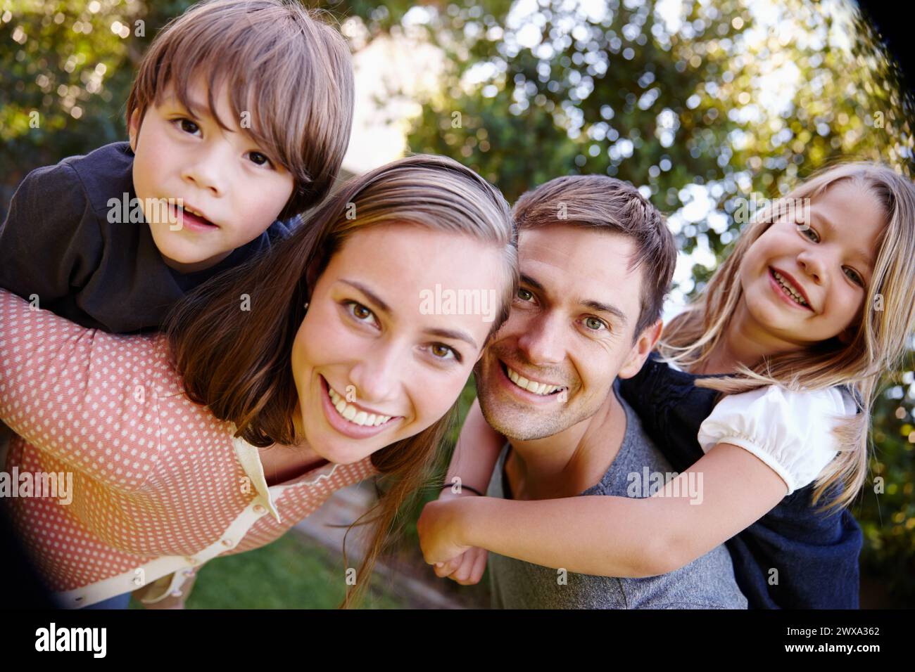 Portrait, smile and family outdoor in nature for love, bonding and ...