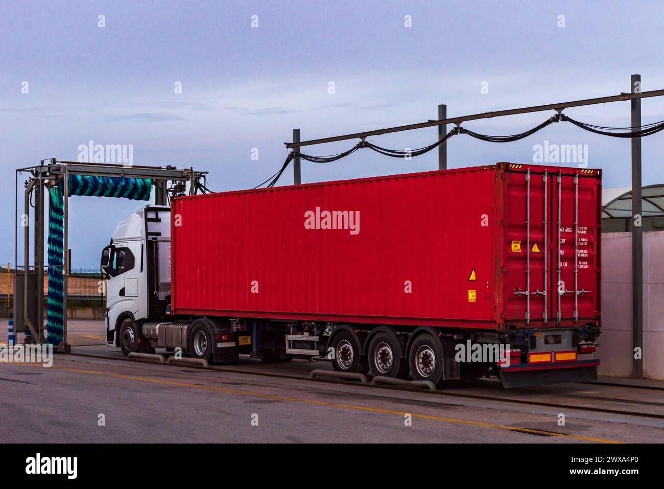 Truck with maritime container placed in a laundry room with rollers for ...