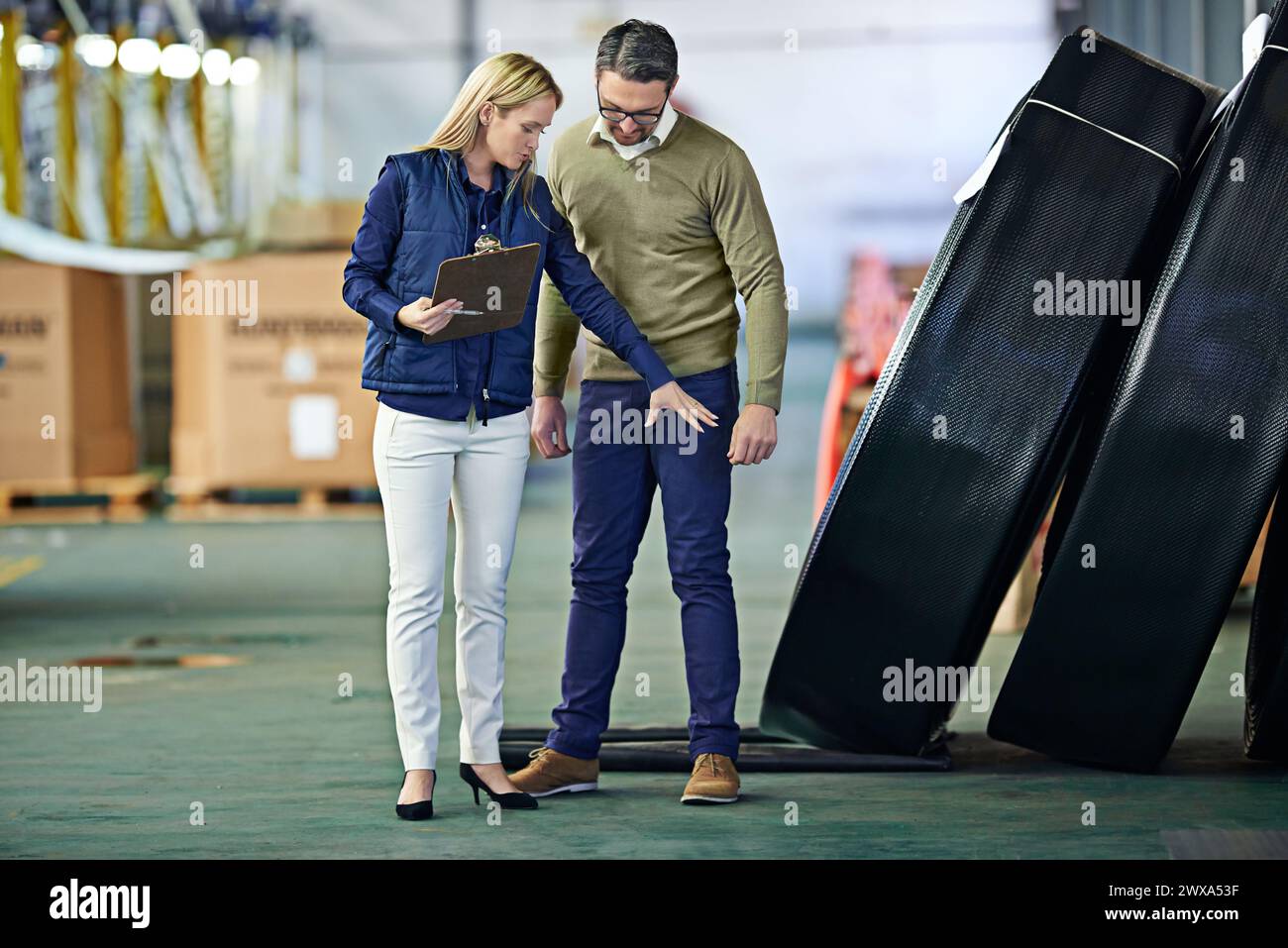 Inventory, logistics and business people with checklist in warehouse ...