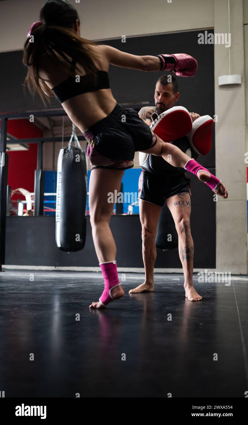 Female fighter practicing Muay Thai with trainer in boxing club Stock ...