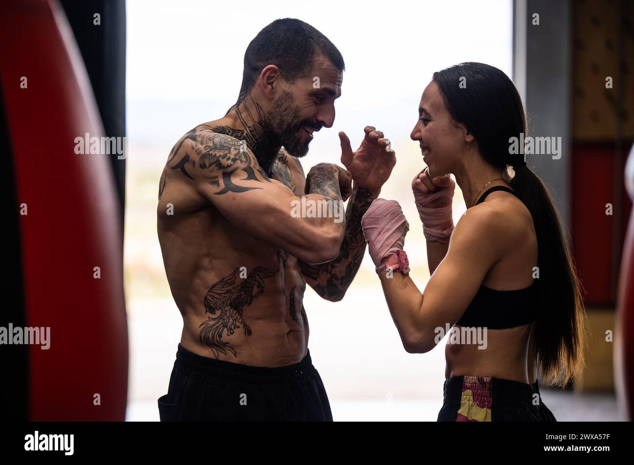 Cheerful couple practicing Muai Thai in gym Stock Photo - Alamy