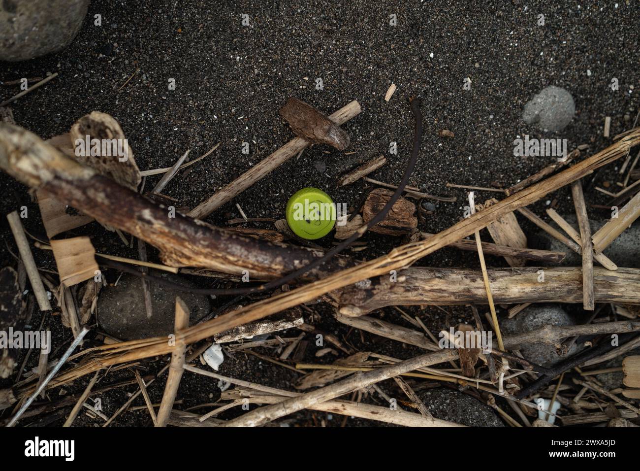 Fun plastic cork on the sand on the beach, environmental pollution ...