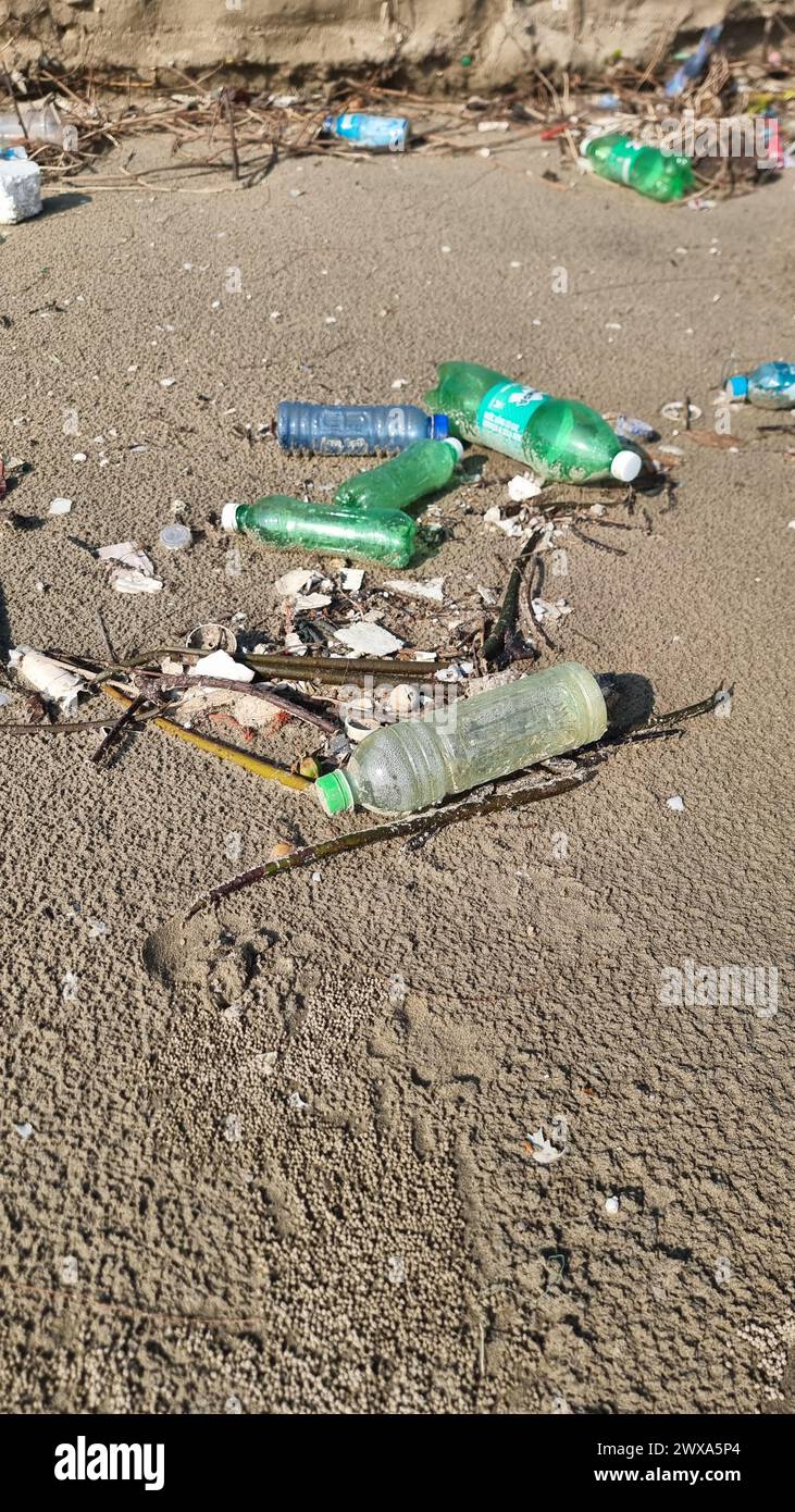 A haunting scene of a pile of plastic bottles and other debris ...